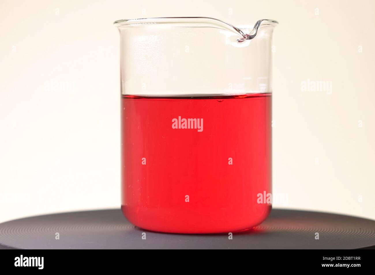 Red liquid in a glass glass. Chemical experiments Stock Photo - Alamy