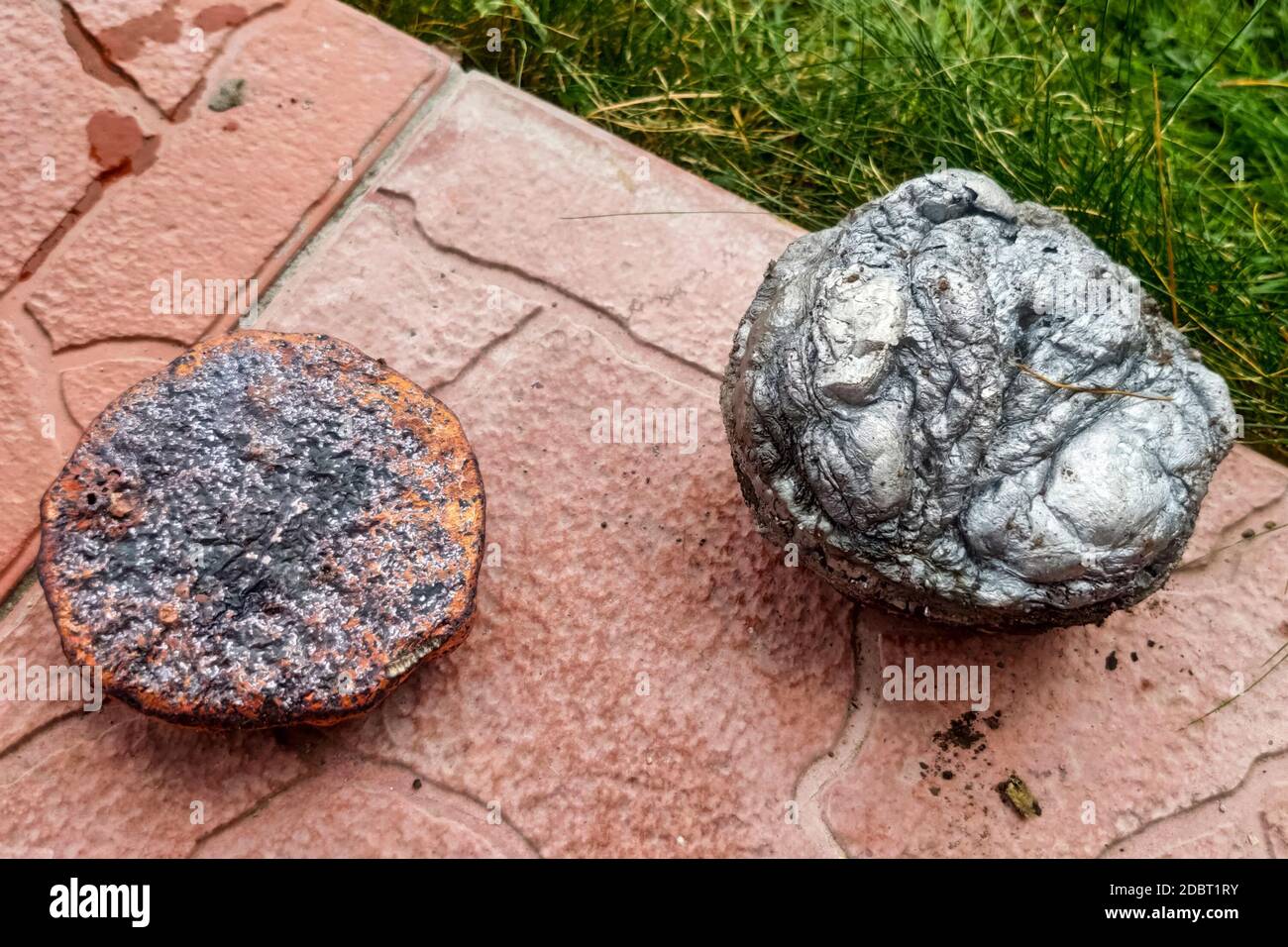 Two pieces of molten metal. Copper pieces of metal Stock Photo - Alamy