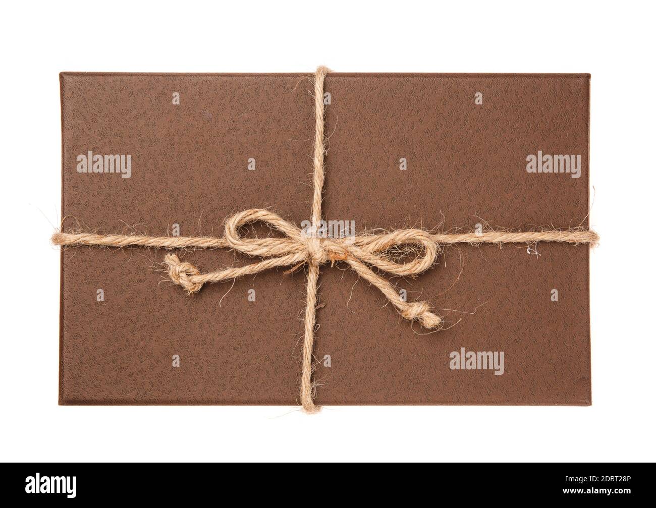 Brown festive gift box with burlap ribbon on white background. Top view ...