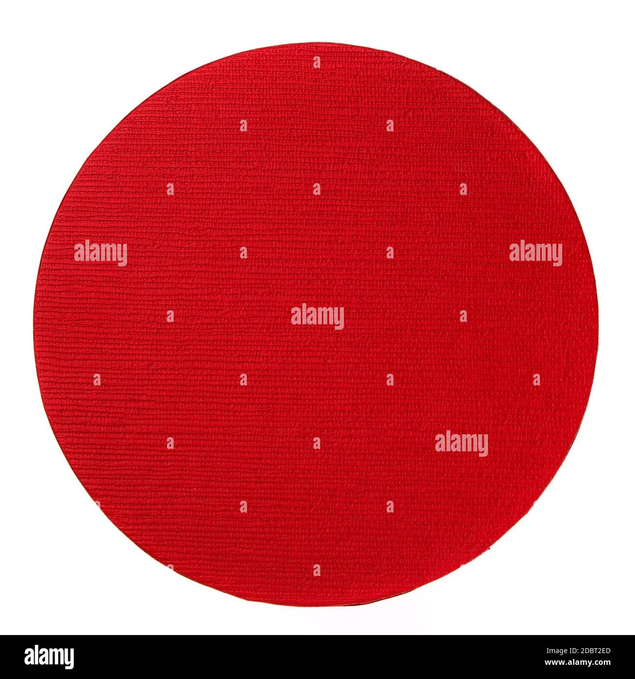 Red round cover from gift box close up on a white background. Top view ...