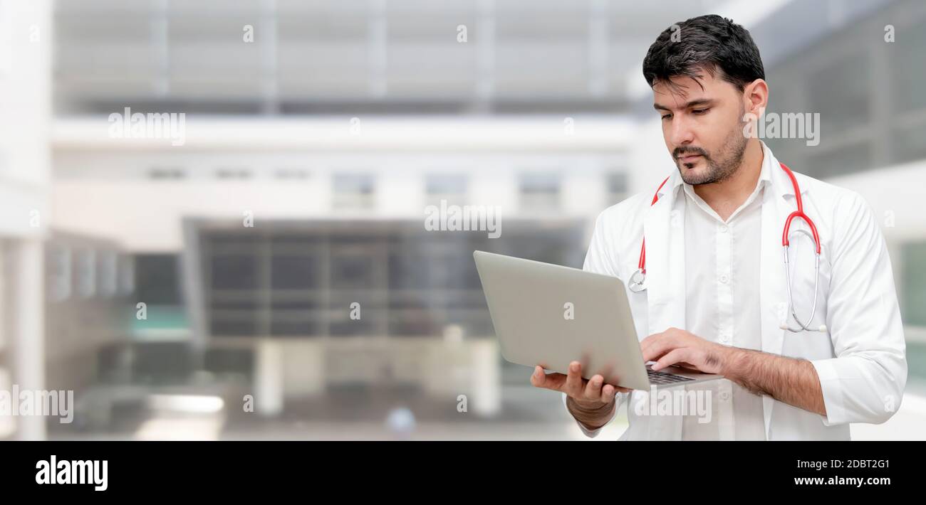 Doctor using laptop computer at the hospital. Medical healthcare and ...