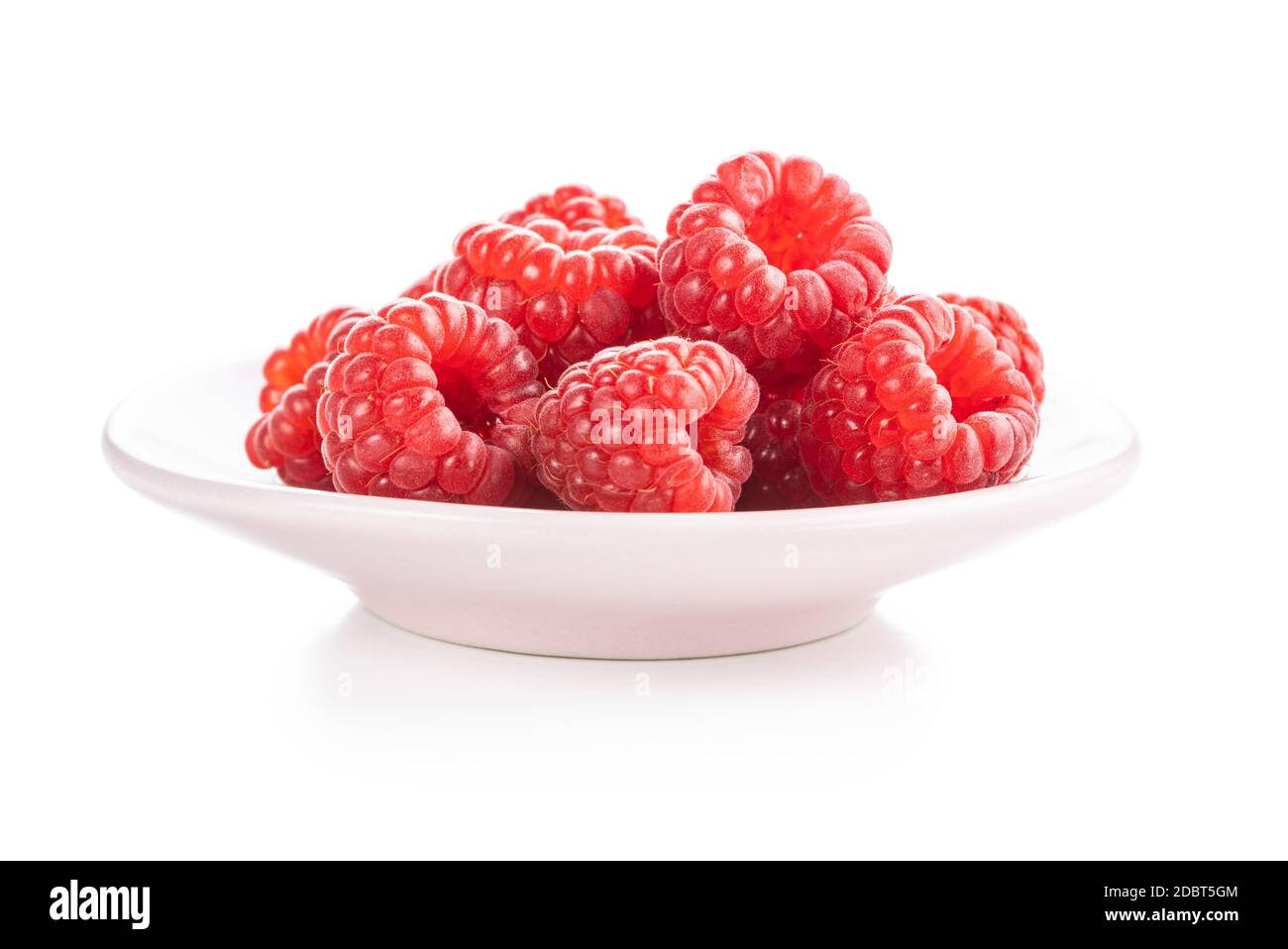 Ripe red raspberries on plate isolated on white background Stock Photo ...