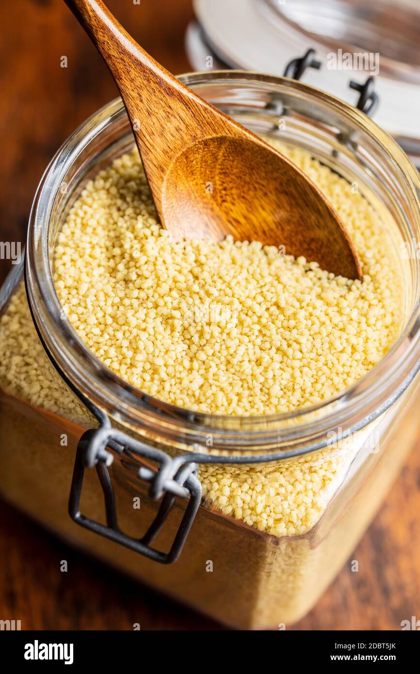 Dry yellow couscous in jar Stock Photo - Alamy