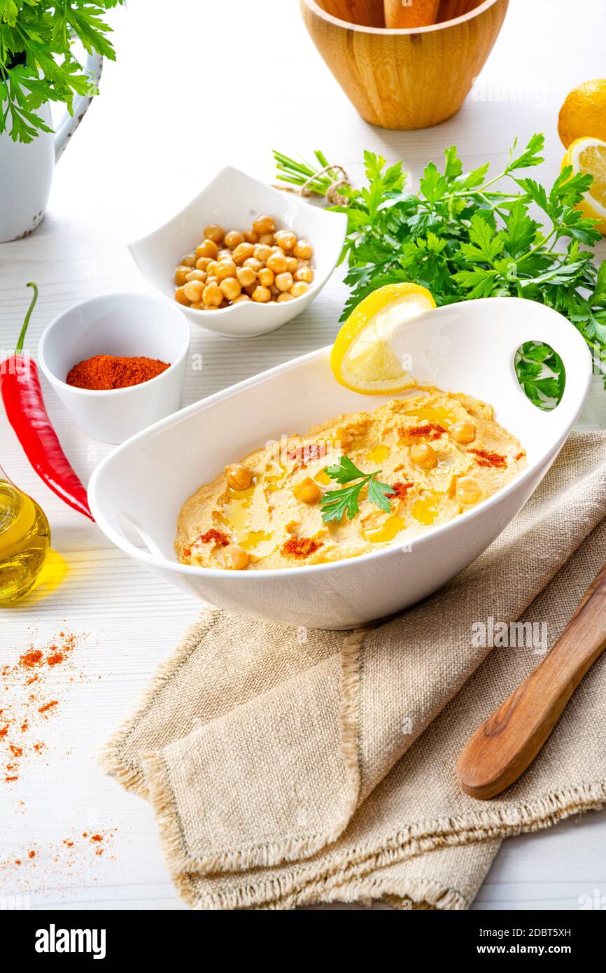 hummus paste with lemon and chilli on white background Stock Photo - Alamy