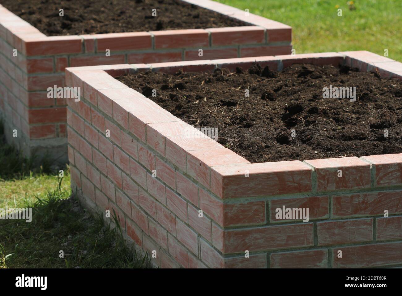 A modern vegetable garden with raised briks beds . Ready for planting ...