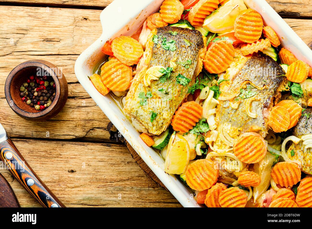 Baked fish steaks with grilled vegetables in baking dish.Delicious ...