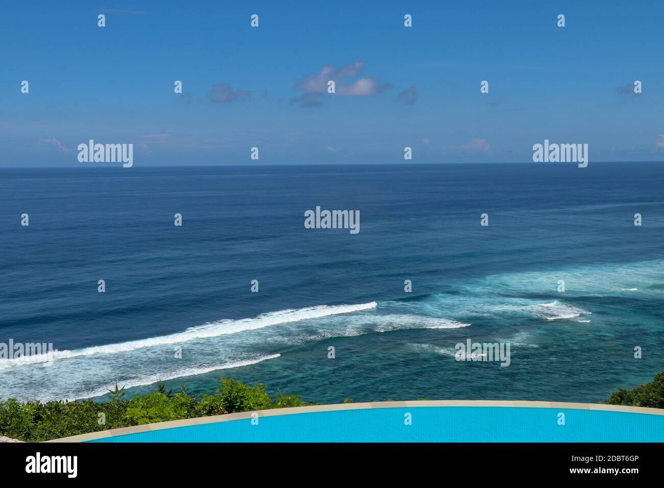 Luxury infinity pool with sea views and palm trees. Bali, Indonesia ...