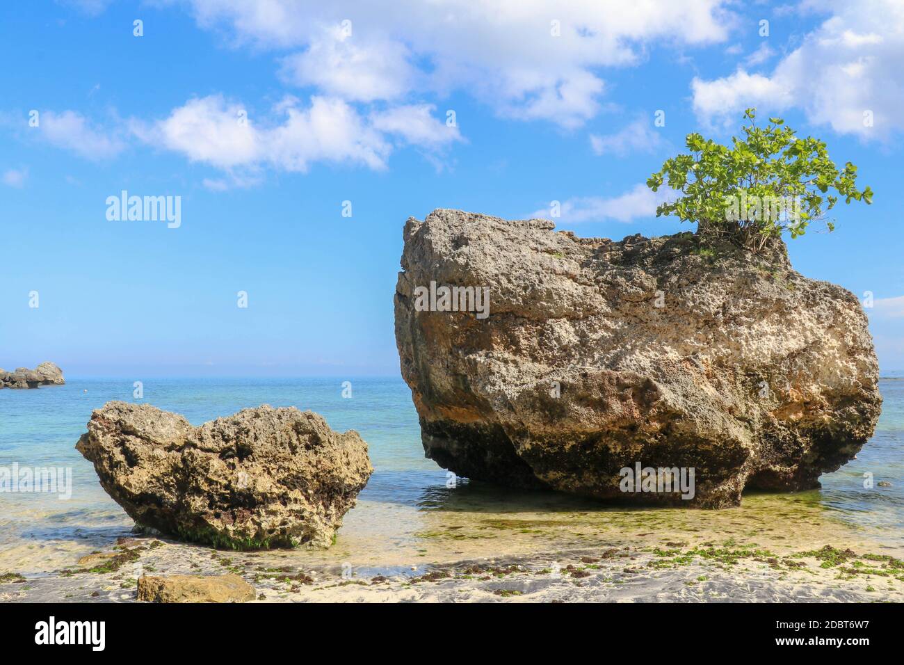 Sea with giant stones and sand island hi-res stock photography and ...
