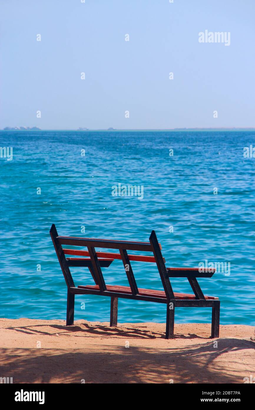View of tropical island with alone bench on seashore. Paradise island ...