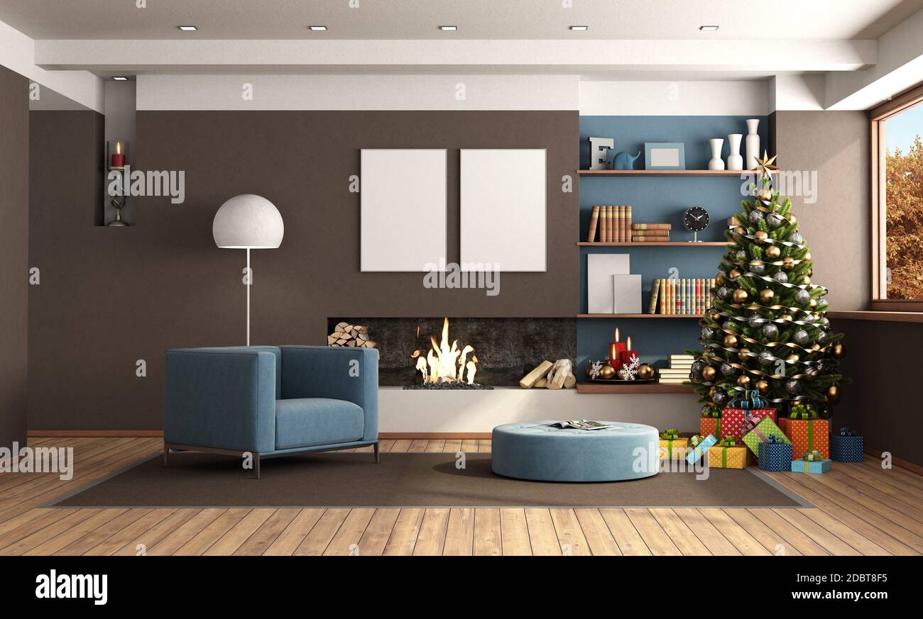 Living room with blue armchair,fireplace and Christmas tree with gift ...