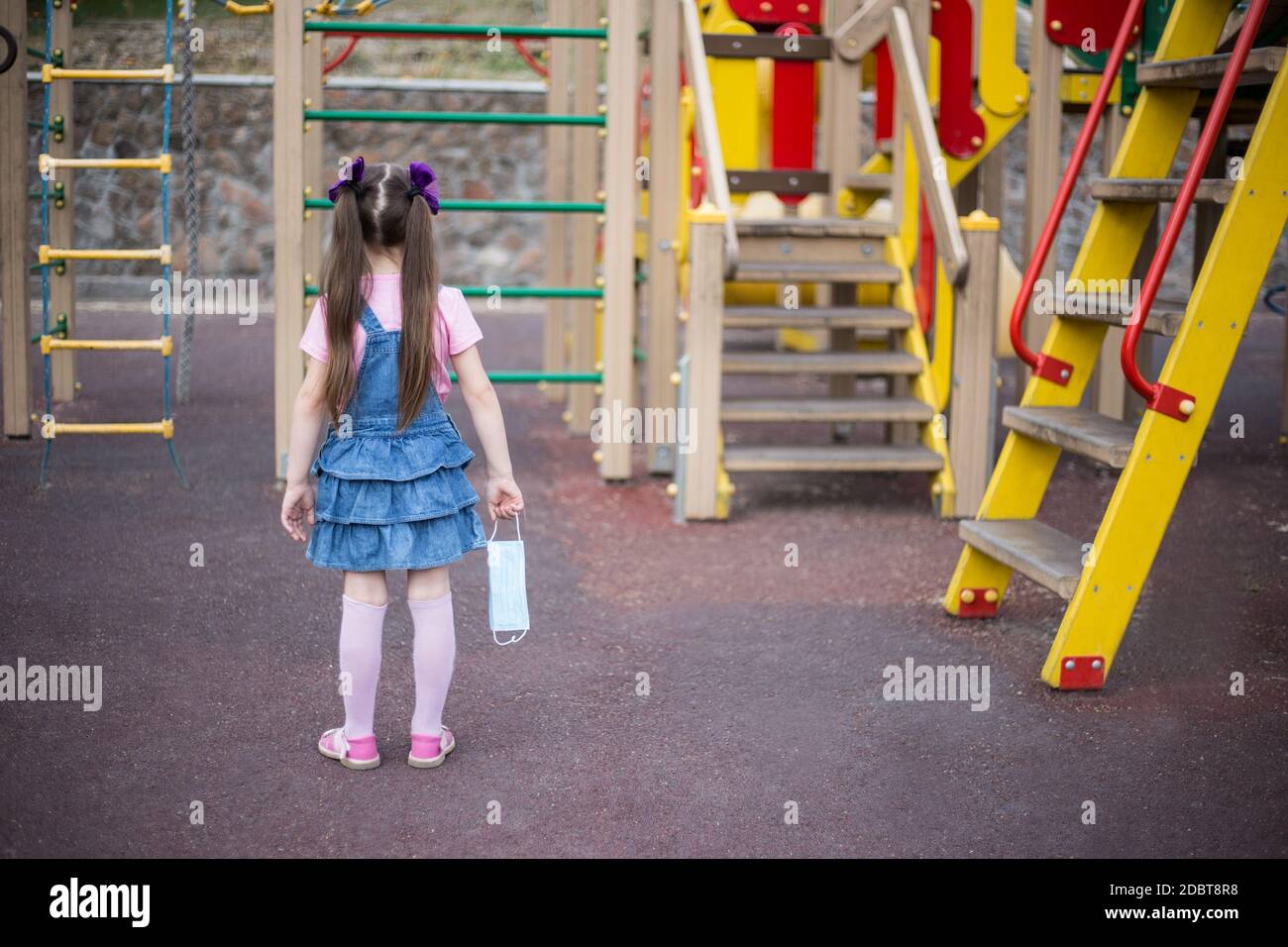 The girl stands alone on the playground, because self-isolation and ...
