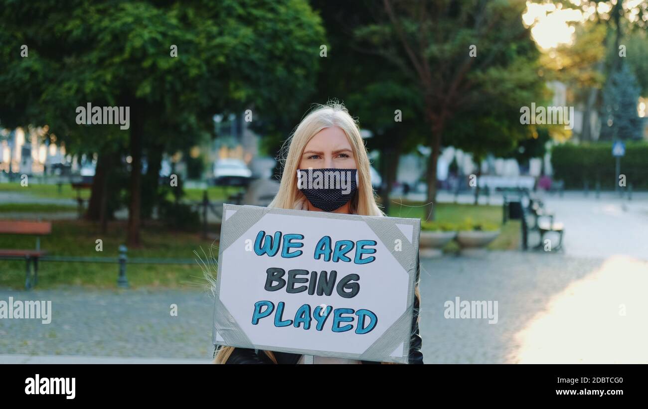 Pretty girl wearing medical mask protesting against authorities that ...