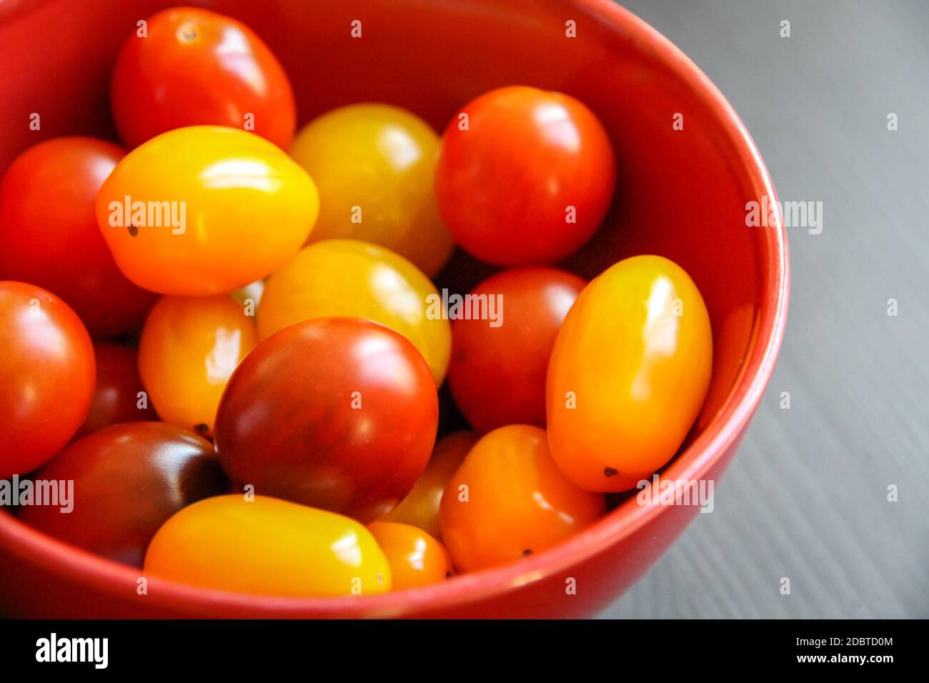 Colorful cocktail tomatoes in a bowl. Top view Stock Photo - Alamy