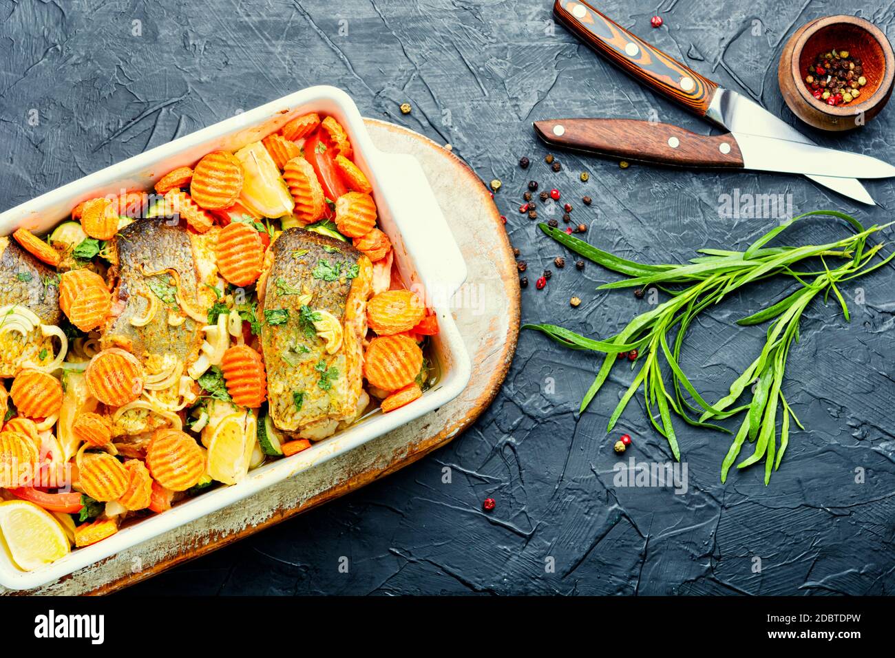 Baked fish steaks with grilled vegetables in baking dish.Delicious ...