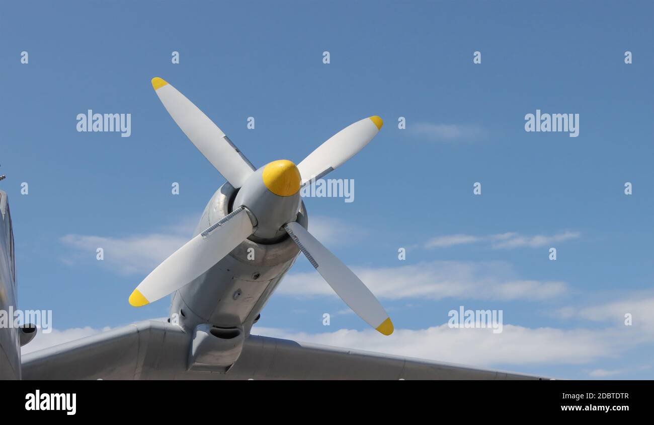 The propeller engine of the aircraft on the wing, against the blue sky ...
