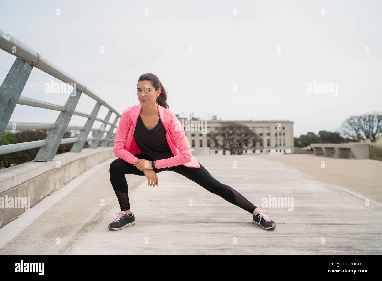 Athletic woman stretching legs before exercise Stock Photo - Alamy