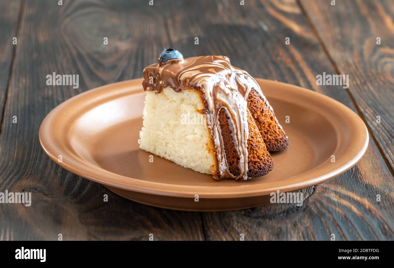 Lemon cake wedge with chocolate topping Stock Photo - Alamy