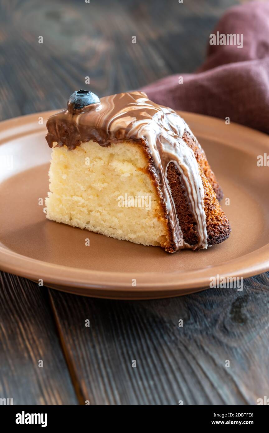 Lemon cake wedge with chocolate topping Stock Photo - Alamy
