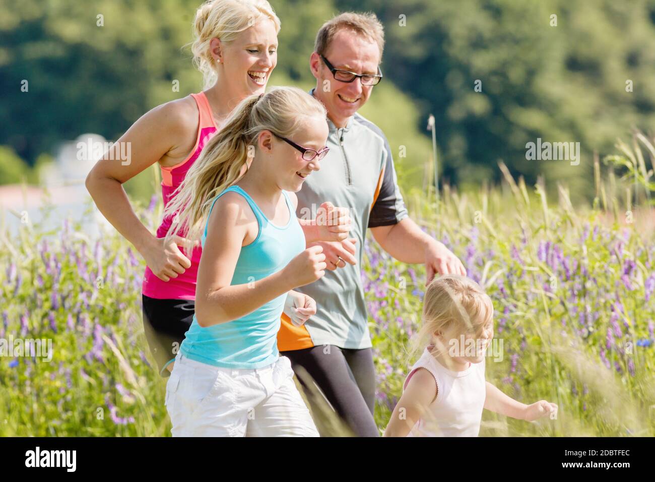 Parents with two children sport running outdoors Stock Photo - Alamy