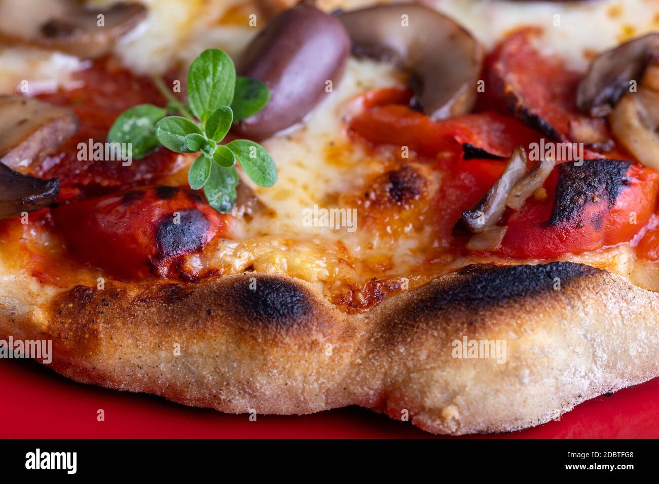fresh pizza on a red background Stock Photo - Alamy