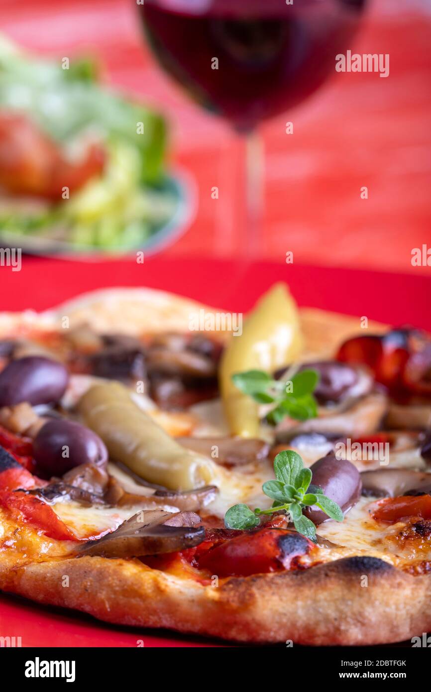 fresh pizza on a red background Stock Photo - Alamy
