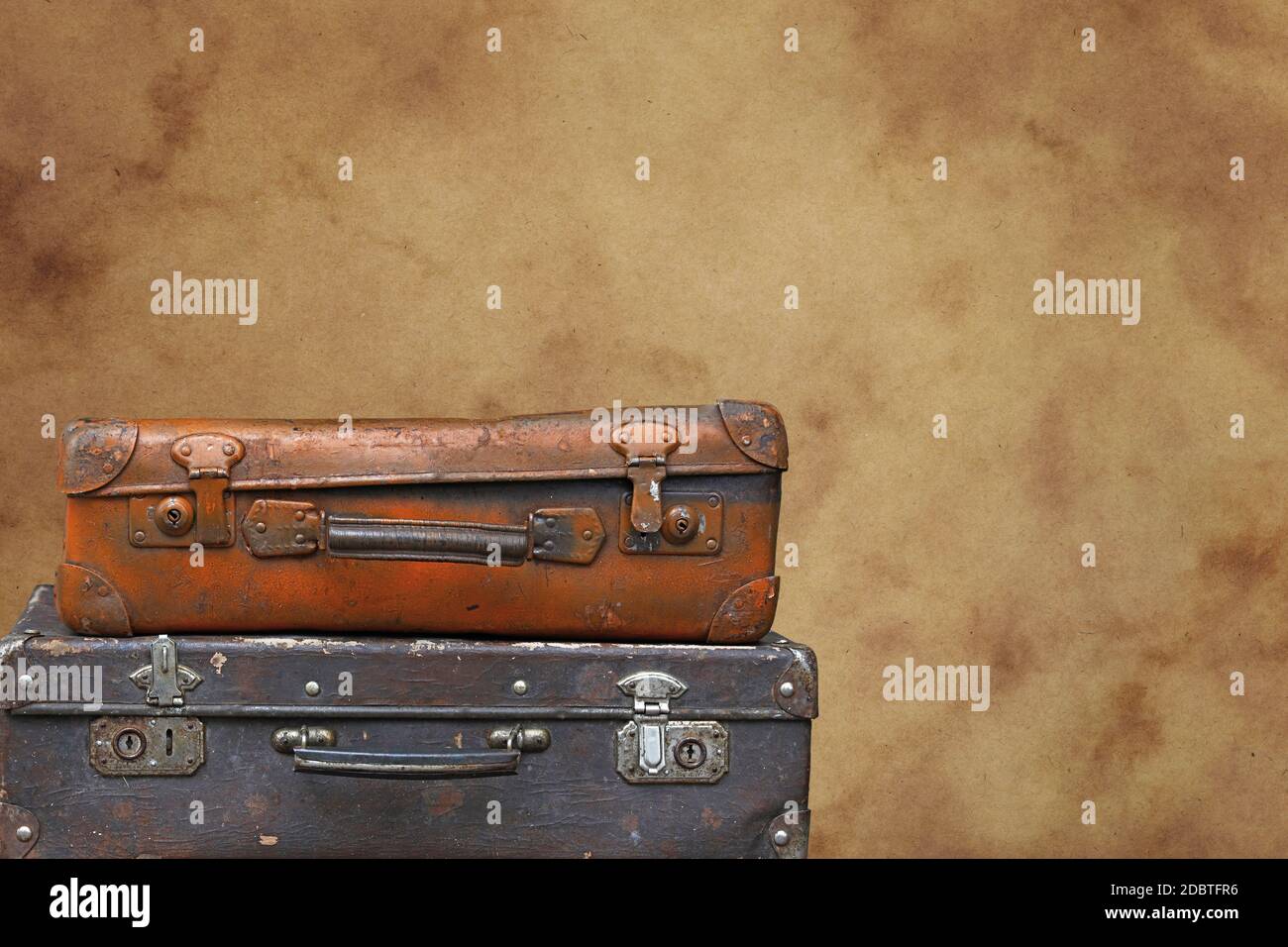 Close up stack of two old vintage antique grunge travel luggage brown ...