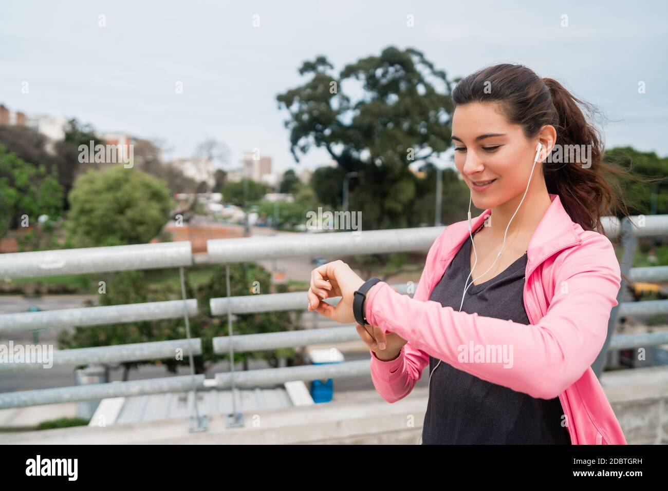 Fitness woman checking time on smart watch Stock Photo - Alamy