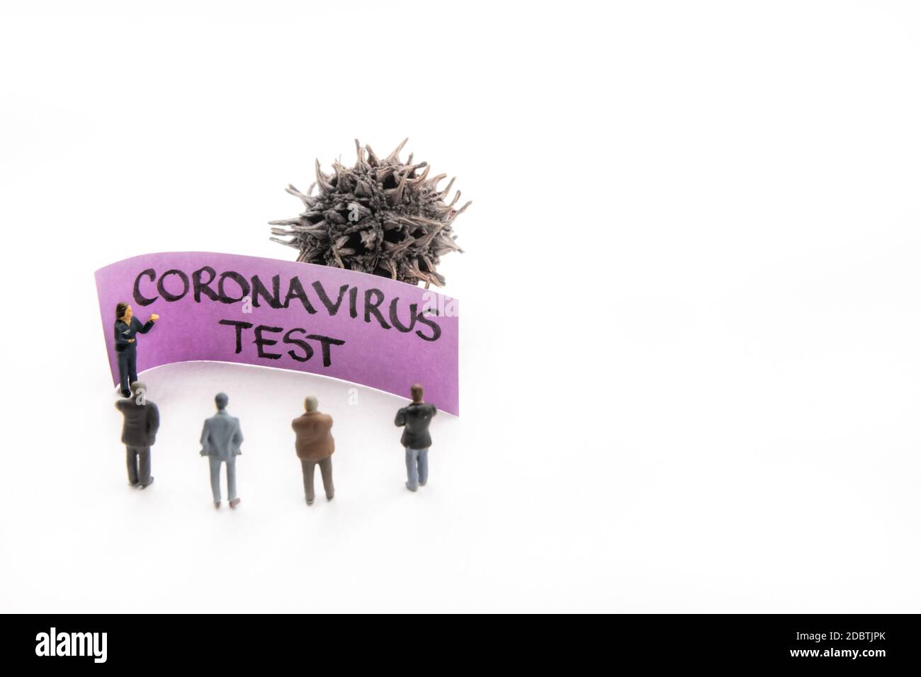 Meeting with miniature figurines posed as business people standing ...