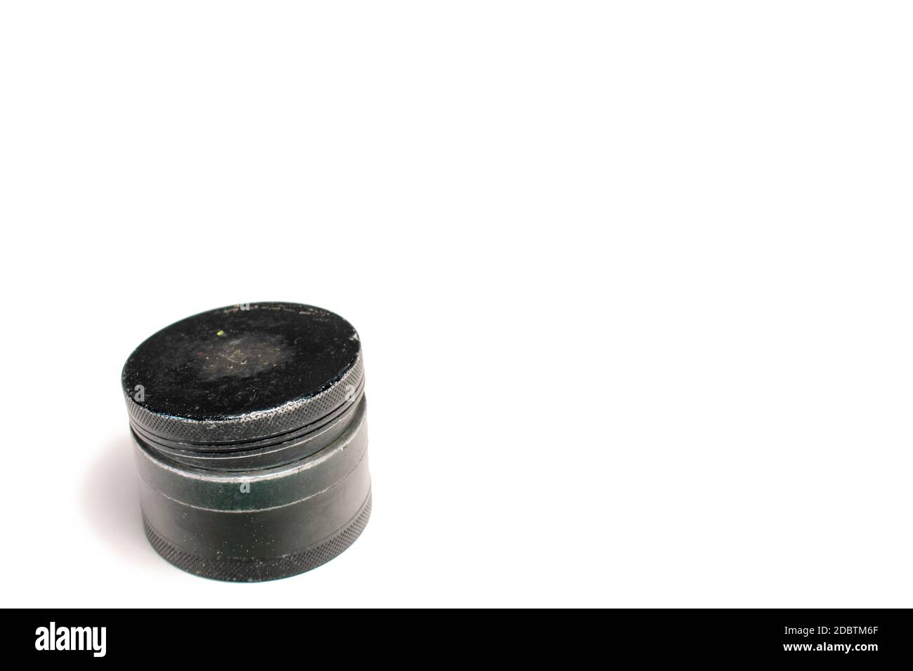 A Black and Used Marijuana Grinder With the Lid Losely Closed Stock ...