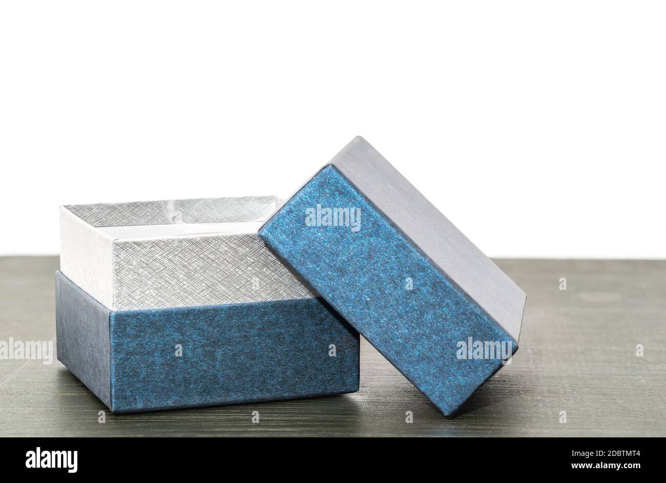 Blue gift box without ribbon on dark background Stock Photo - Alamy