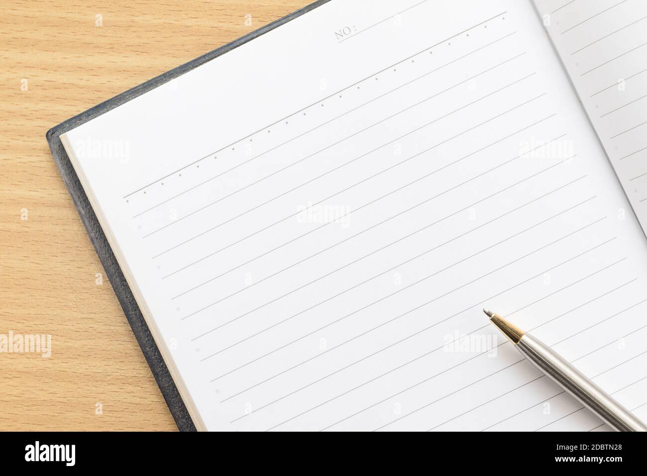 Open notebook with blank page and pen on wood table Stock Photo - Alamy
