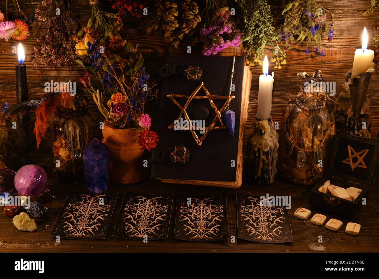Still life with pentagram book, tarot cards, runes dry flowers and ...