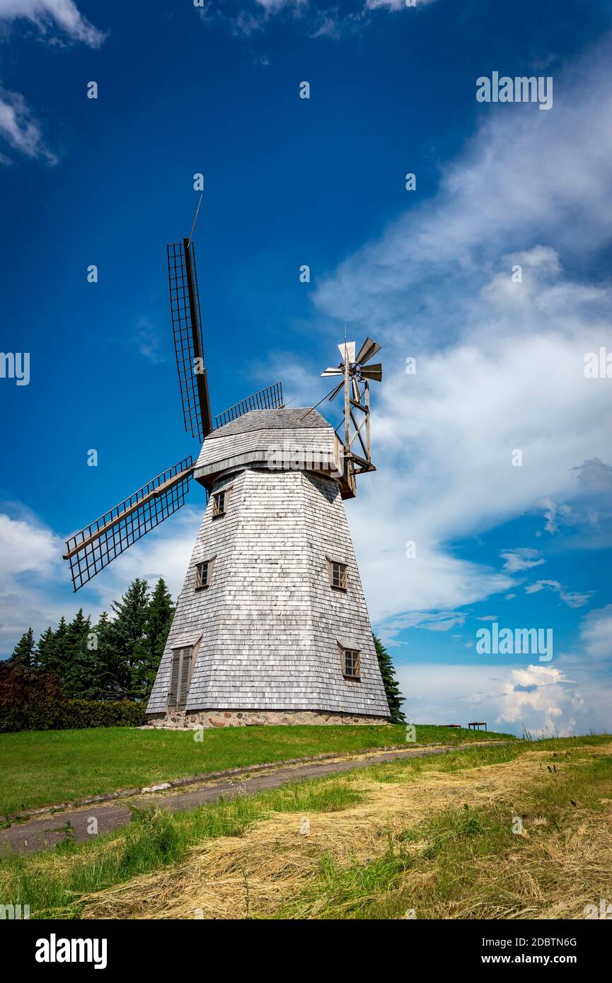 Old windmill in grassland in a country landscape under a cloudy blue ...