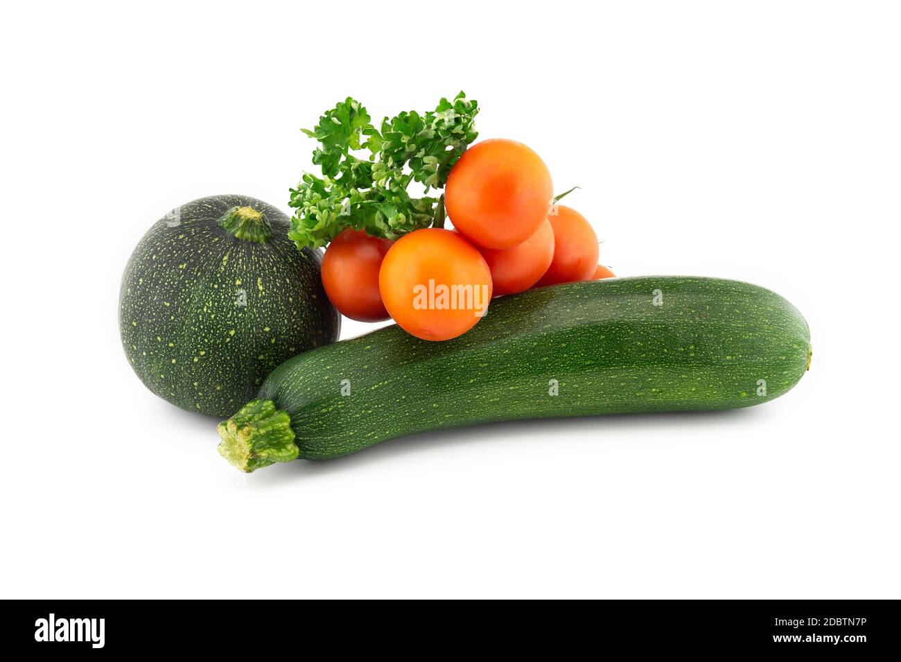 Green round and traditional courgette or zucchini, cherry tomato twig ...