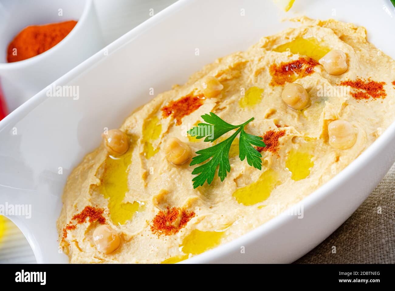 hummus paste with lemon and chilli on white background Stock Photo - Alamy