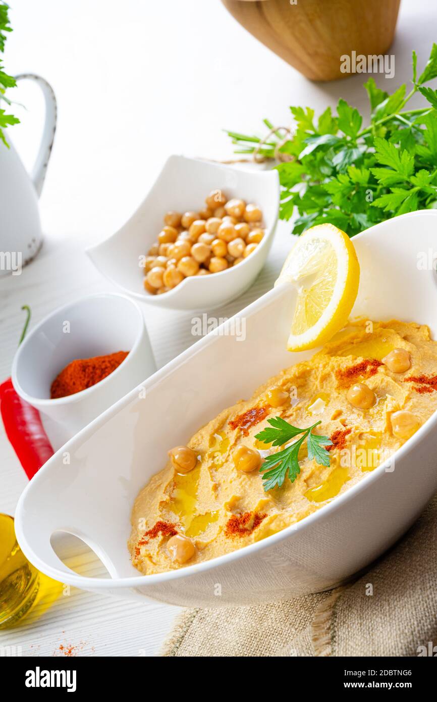 hummus paste with lemon and chilli on white background Stock Photo - Alamy