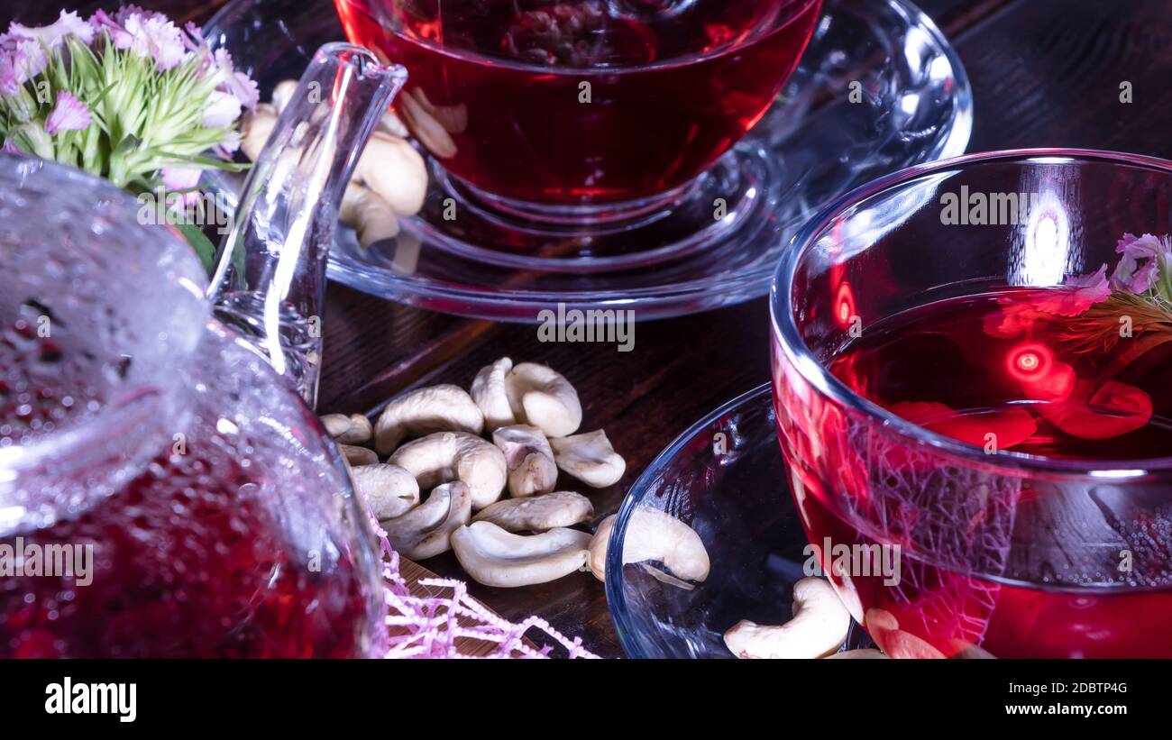 Hibiscus Red tea mug with carnation flowers close-up horizontal photo ...