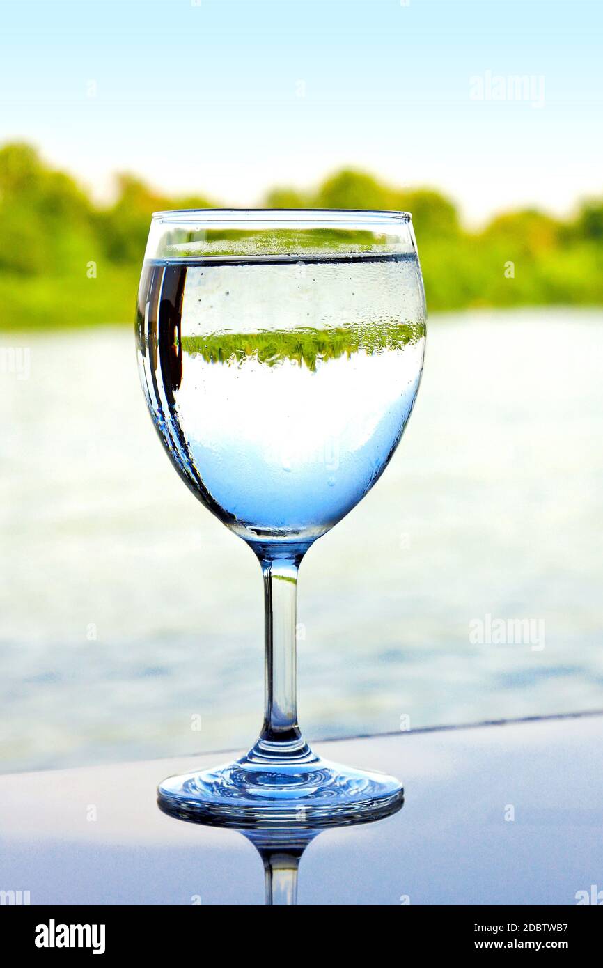 Reflection of river coast in water glass Stock Photo - Alamy