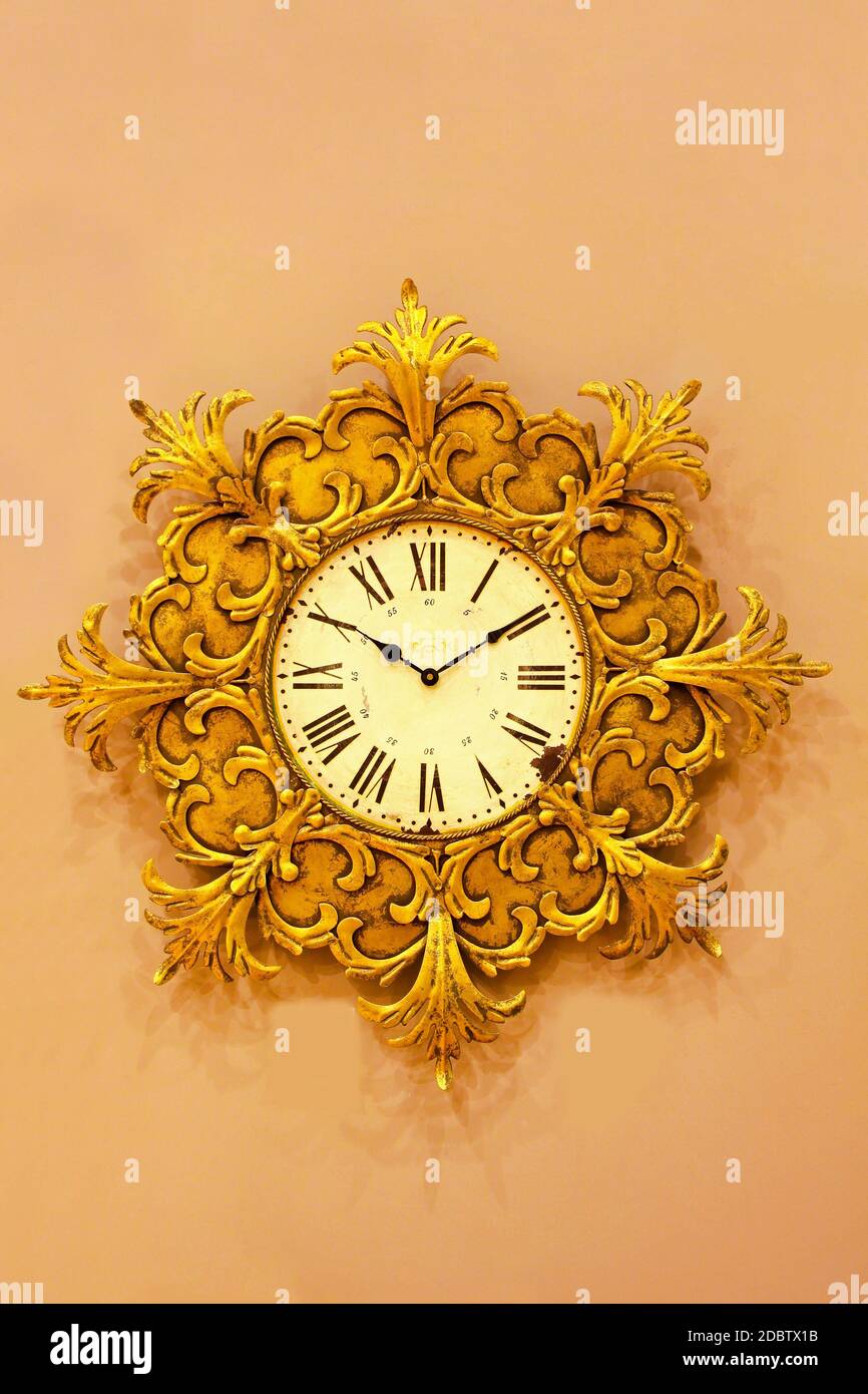 Antique clock with decorative frame on the wall Stock Photo - Alamy