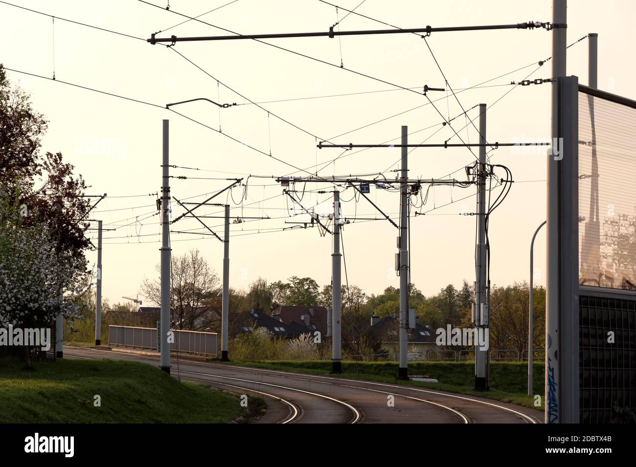 Tram rails and cables scenery. Tramway tracks and traction photo. Overhead electric wires and ...