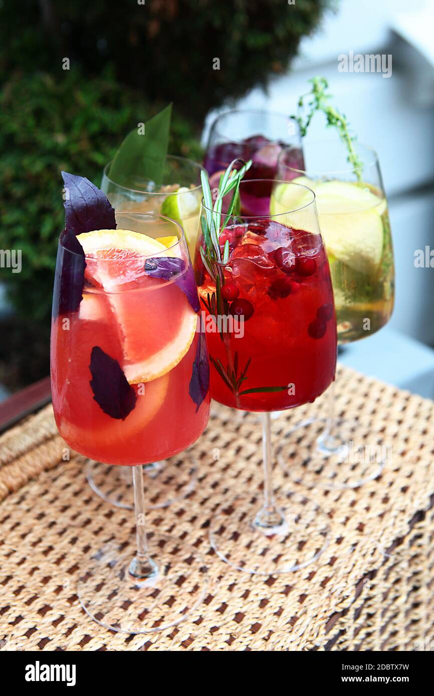 Assorted cold drinks in tall glasses. Vertical photo. Lemonades on a ...