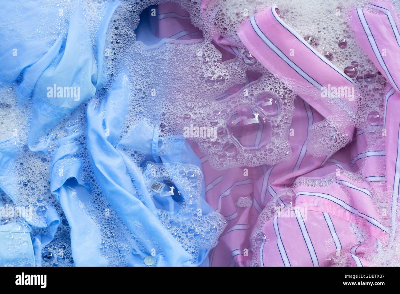 Top view of color clothes soak in powder detergent water dissolution ...