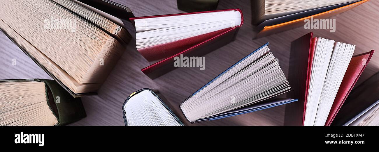 Books on the table, top view. In books, the sheets are spread out in ...