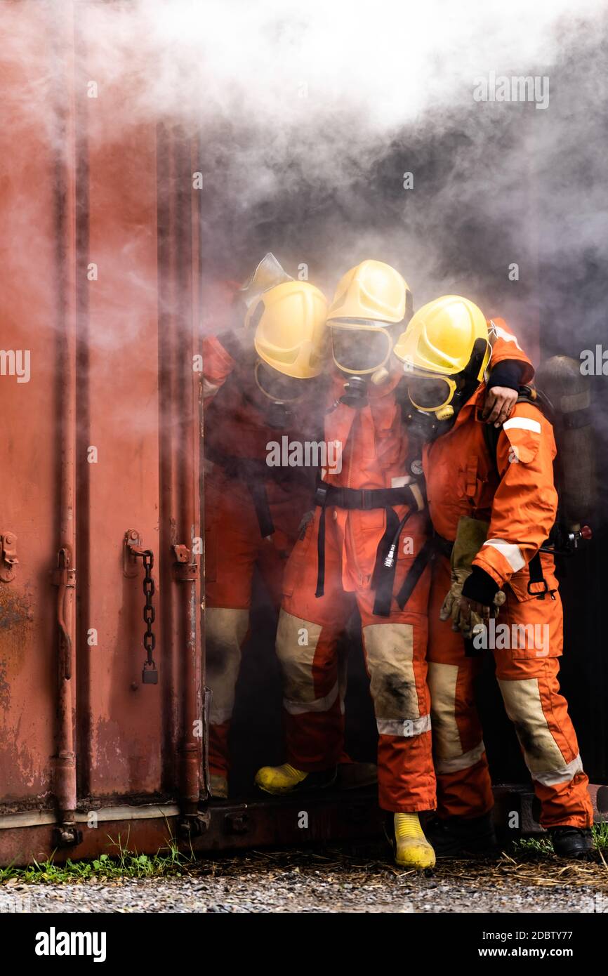 Asian firefighters rescue their team colleague from from burning ...