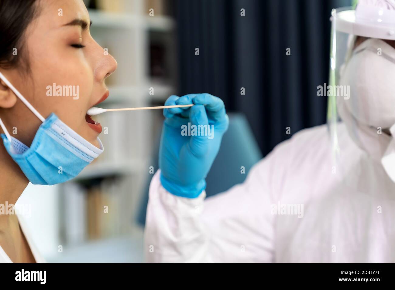 Medical staff with PPE suit test coronavirus covid-19 to asian woman by ...