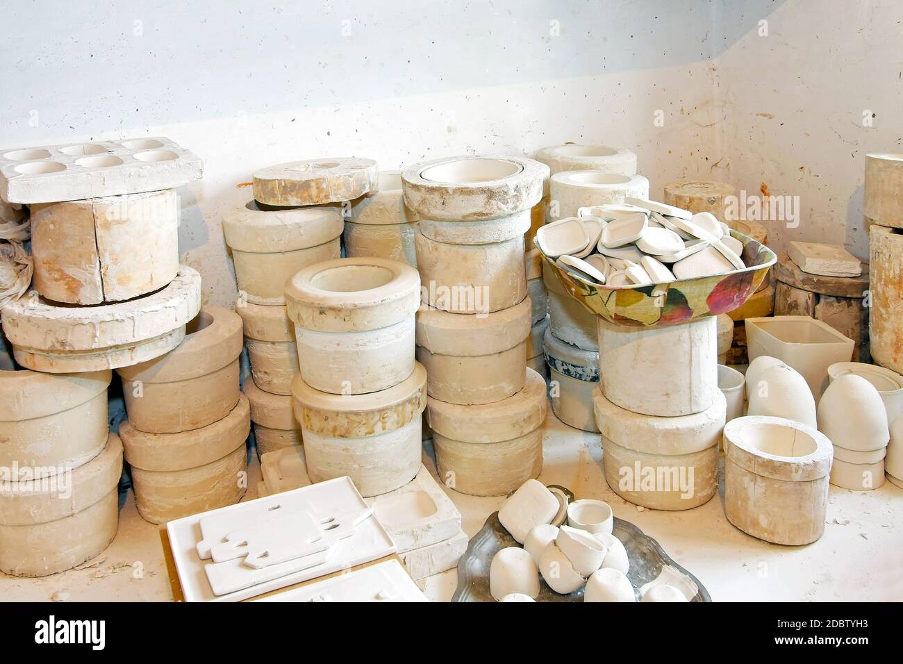 Ceramic production work bench with blank pottery Stock Photo - Alamy