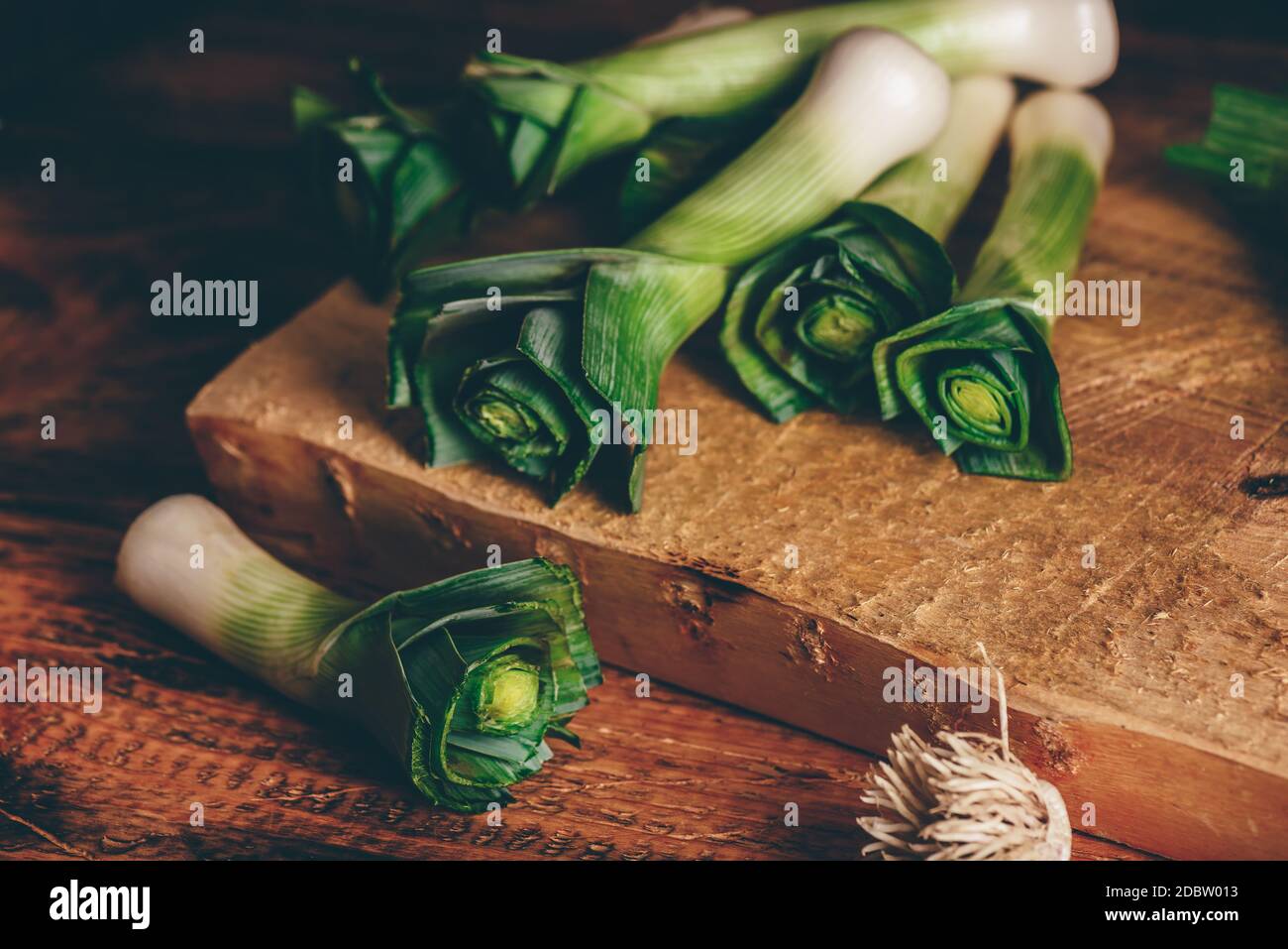 Fresh green leek on rustic cutting board Stock Photo - Alamy