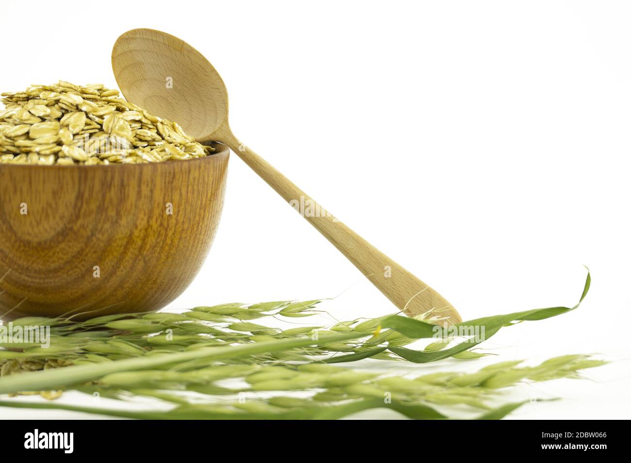 Green ear of oats with bowl of cereal in the background isolated on ...
