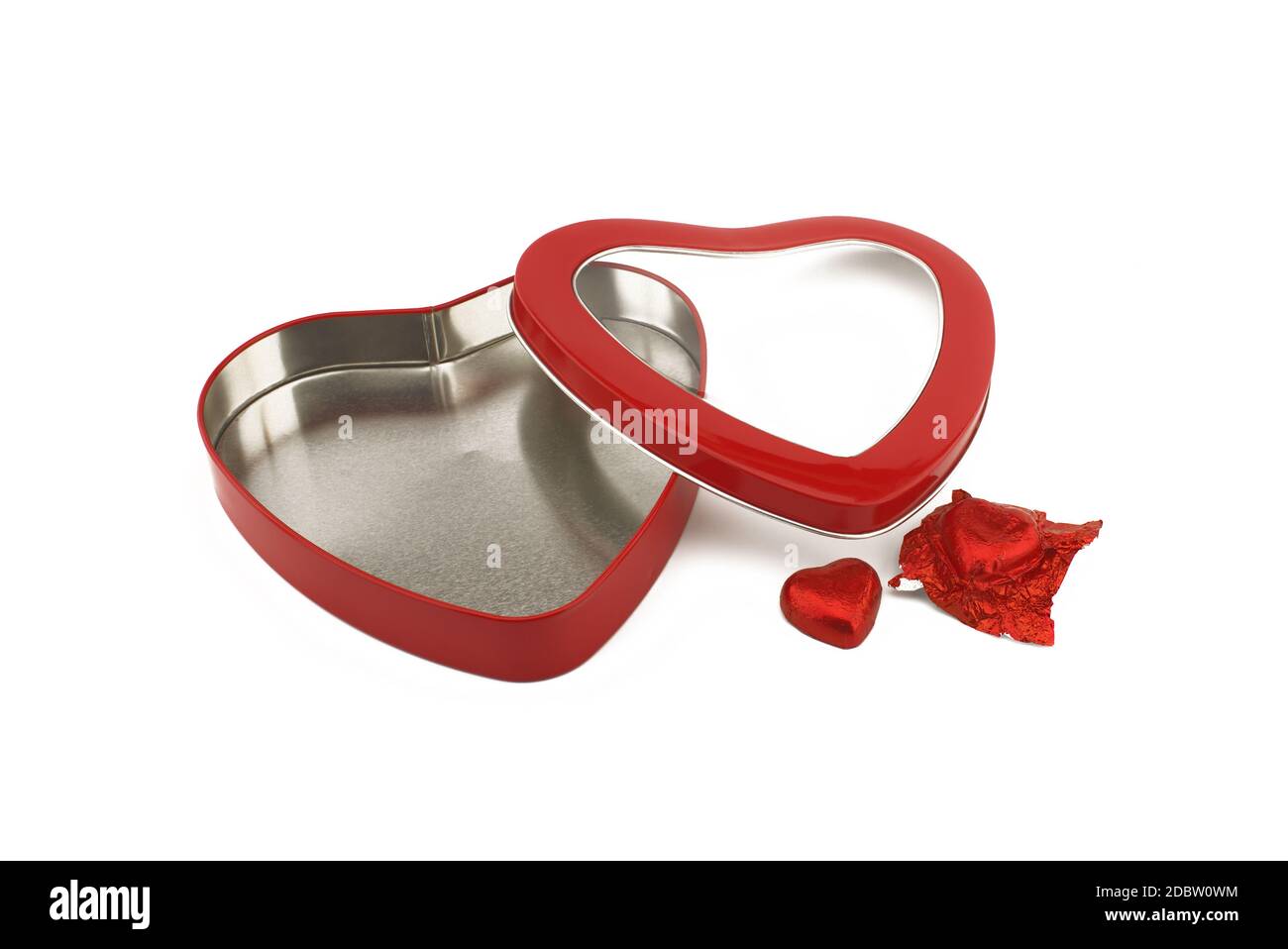 Red heart shaped box with chocolate candy on a white background with ...
