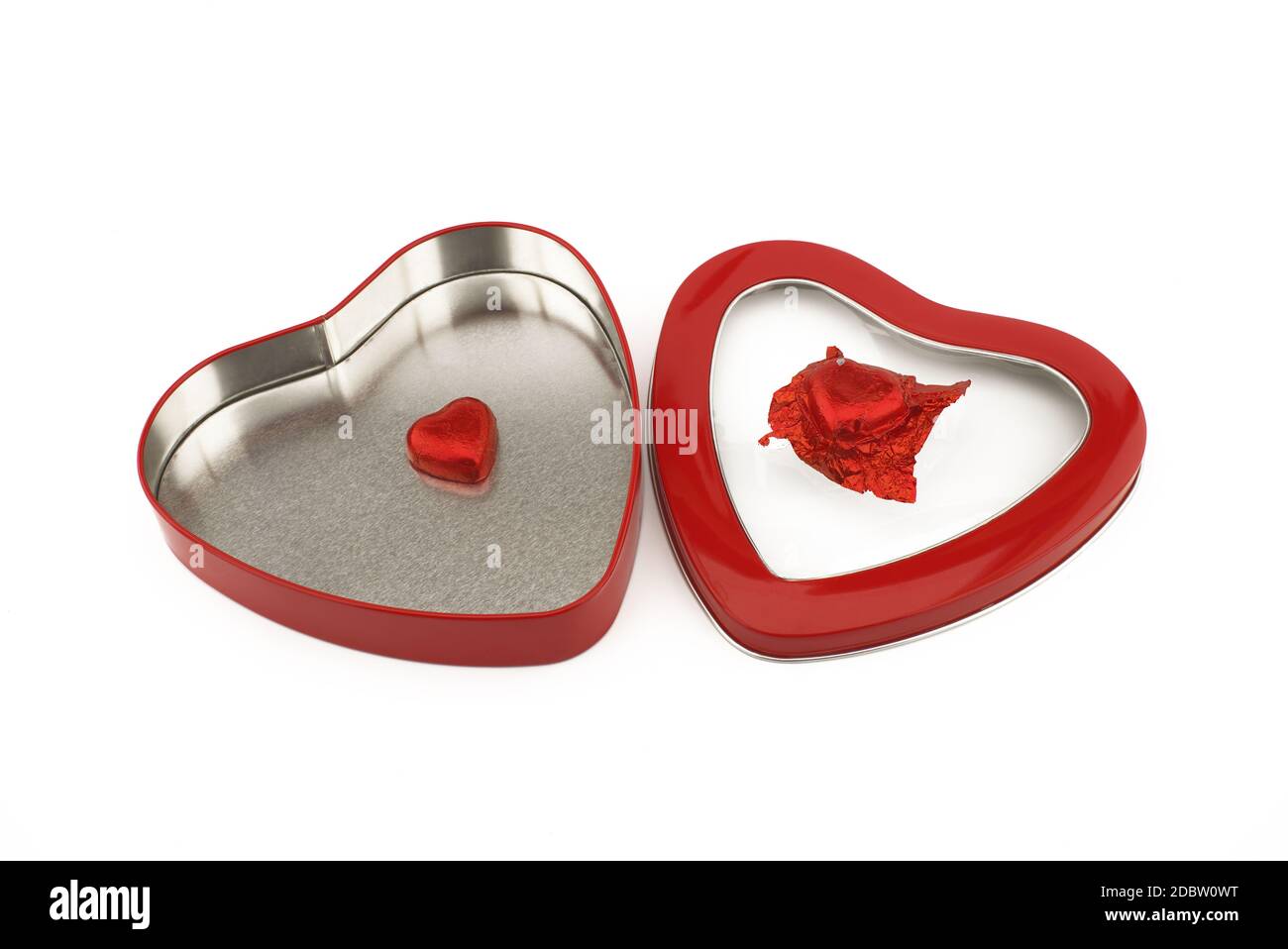 Red heart shaped box with chocolate candy on a white background with ...